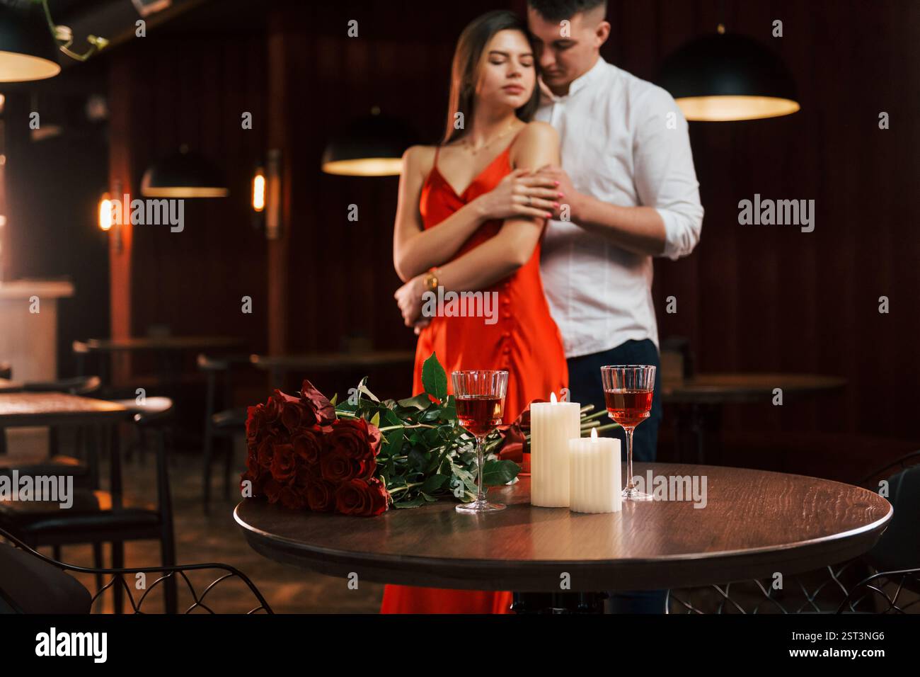 Two people standing together. Romantic couple have dinner in the ...