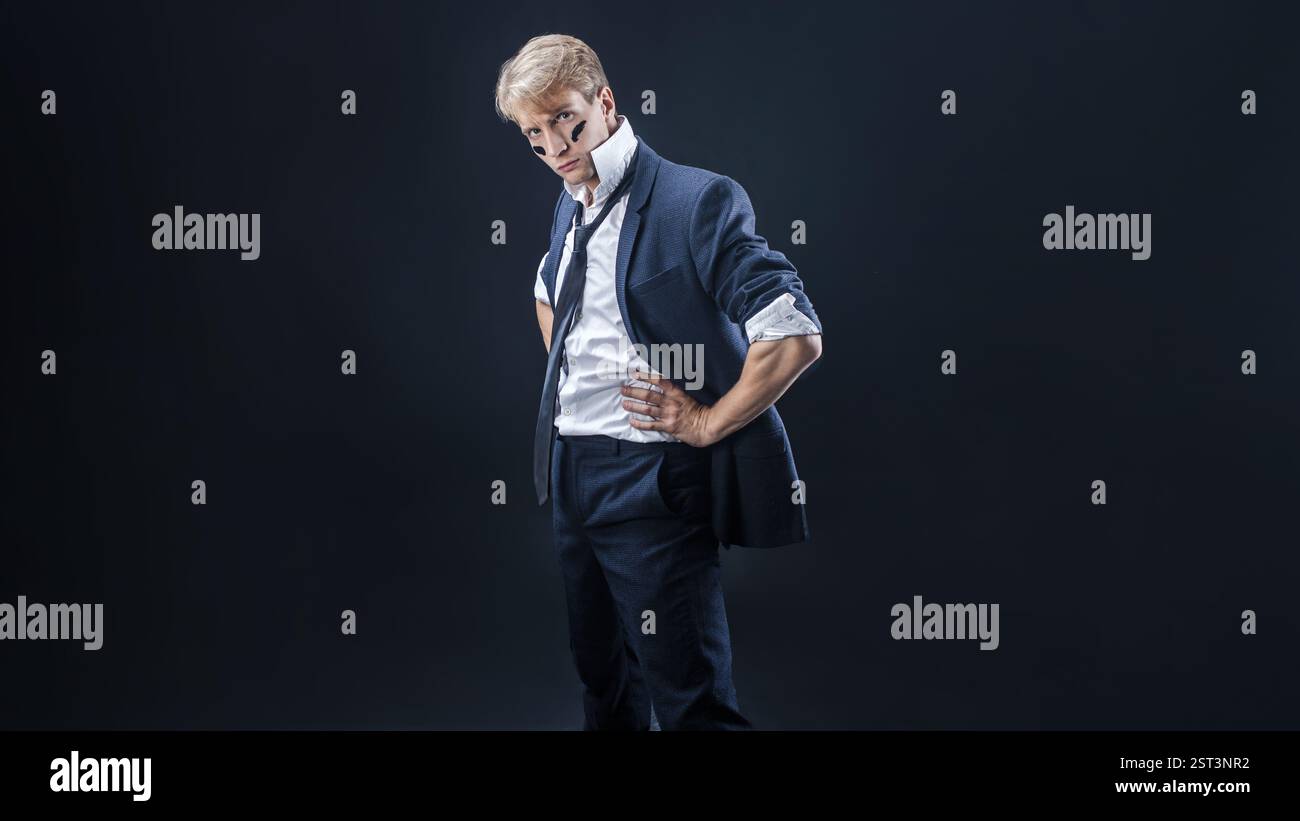 An aggressive businessman with war paint on his face is preparing for ...