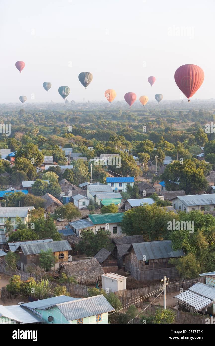 Myanmar, Bagan, views of hot air balloons over local housing in rural ...