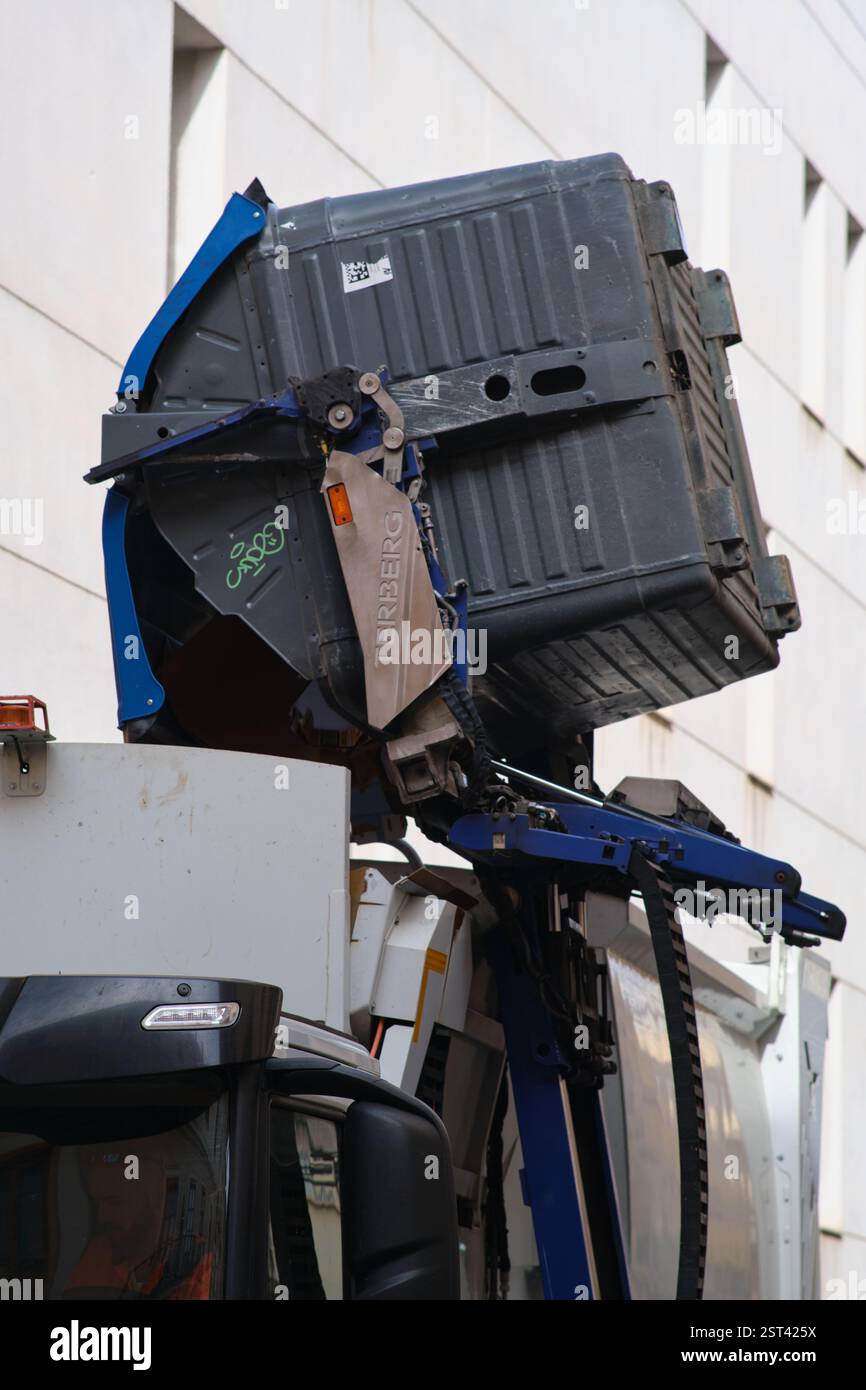 Garbage truck empties bins in the gorol Close-up of the ascent Stock ...