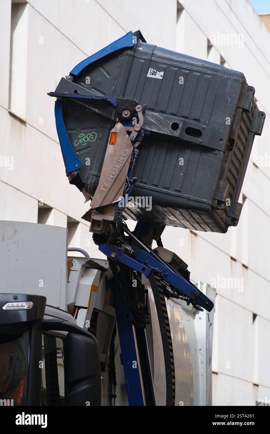 Garbage truck empties bins in the gorol Close-up of the ascent Stock ...