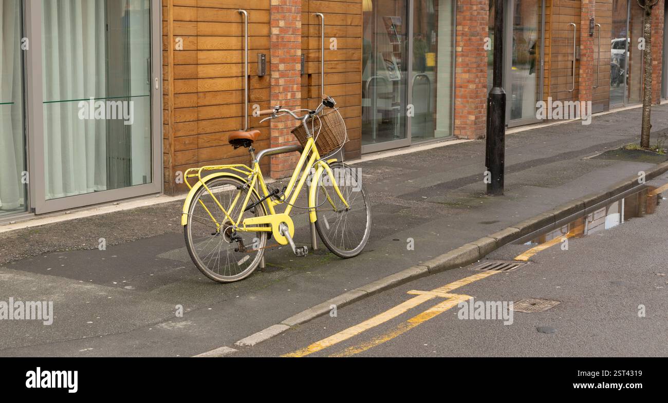 Manchester, uk, January 19th 2025 Old fashioned yellow bicycle standing ...