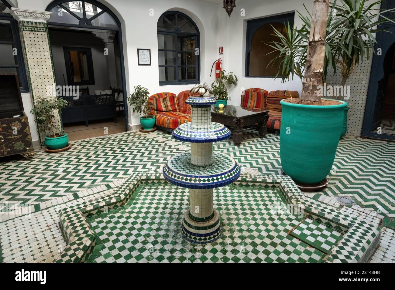 Traditional riyad internal yard with small fountain in Marakkesh ...