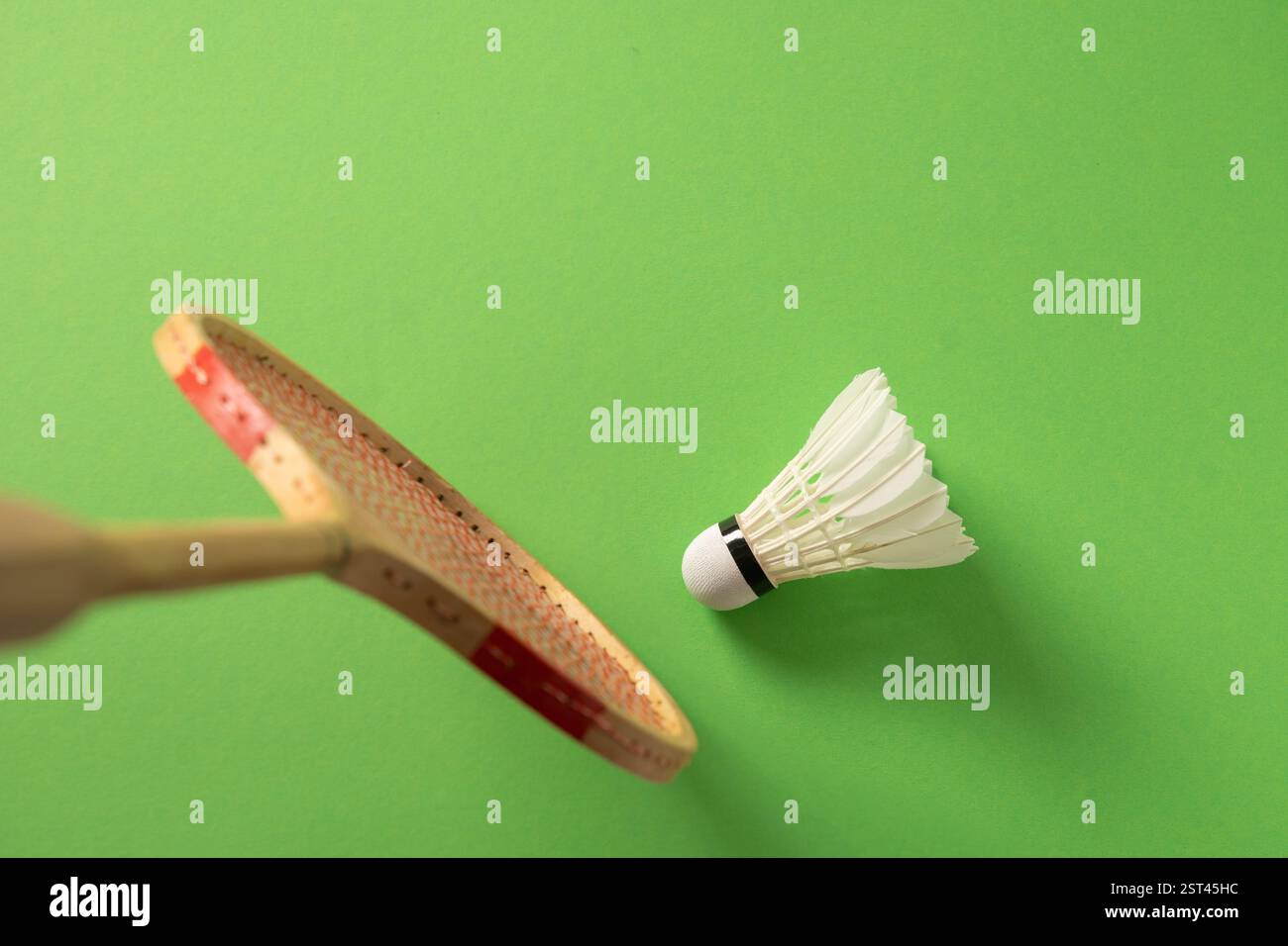 Wooden badminton racket and white feather badminton shuttlecocks on ...