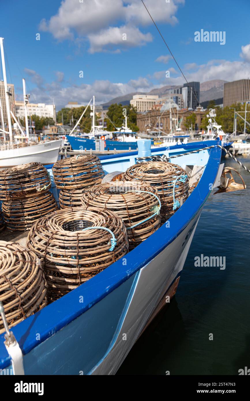 Fishing boat with stacked lobster pots at harbour Stock Photo - Alamy