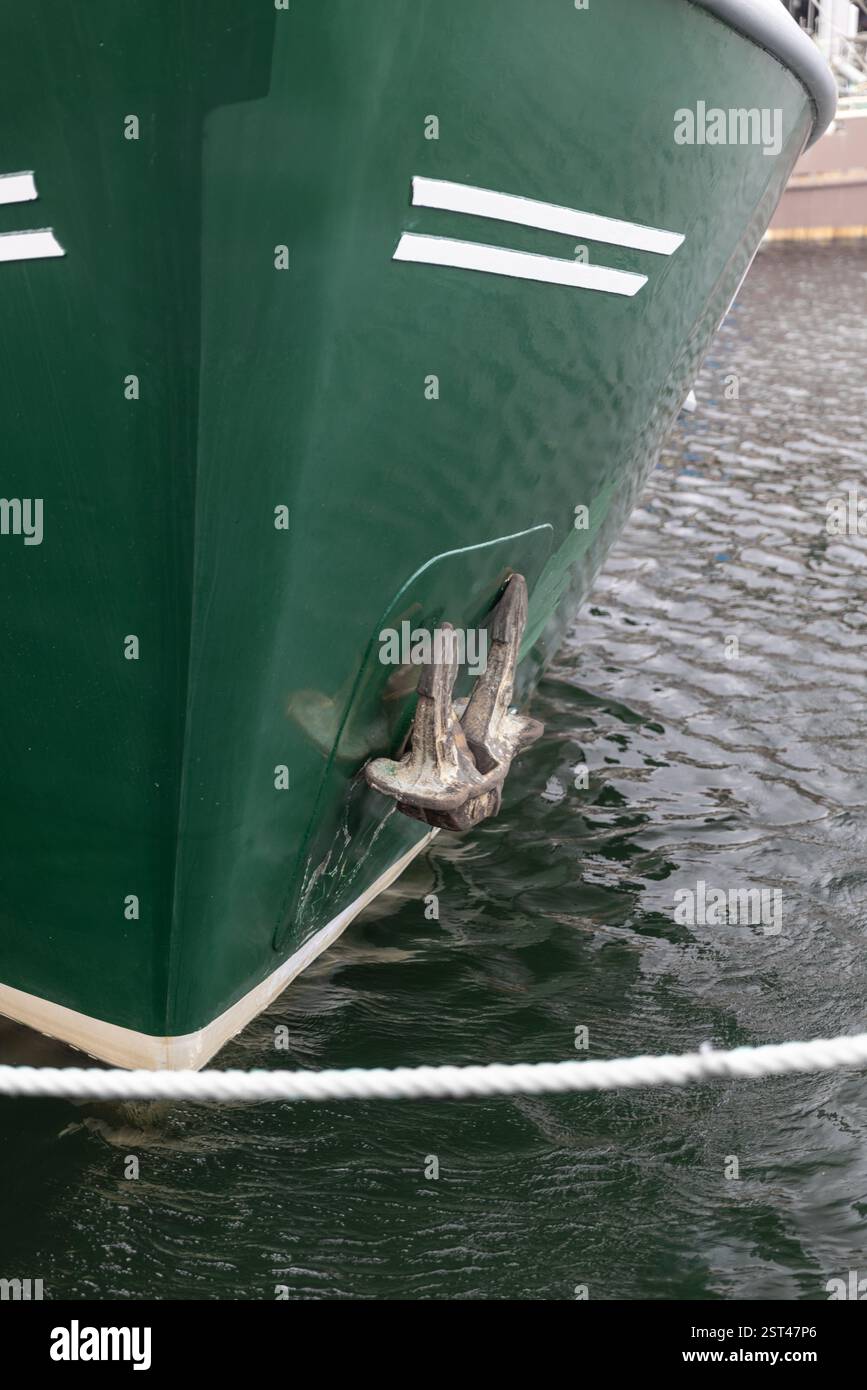 Green boat hull with white stripes and anchor moored Stock Photo - Alamy