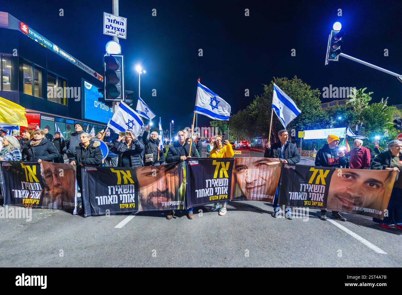 Haifa, Israel - February 15, 2025: People holding hostage posters, text ...