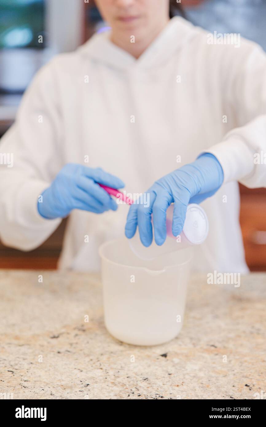 Artisan pouring and mixing ingredients for homemade soap Stock Photo ...