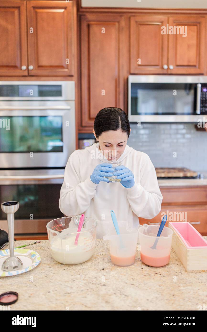 Woman smelling fragrance before adding it to handmade soap in Stow ...