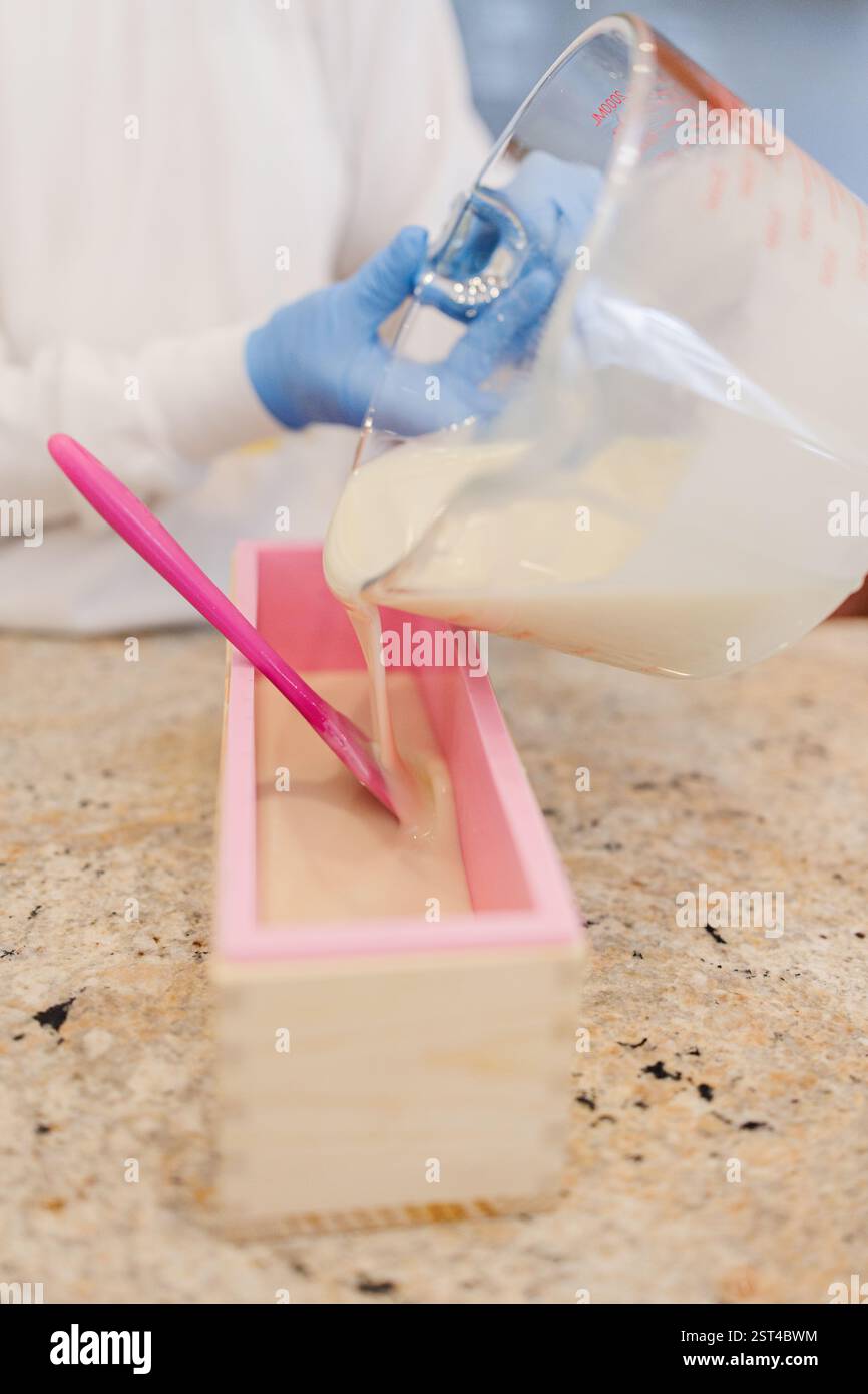 Woman pouring handmade soap mixture into a mold in Stow Stock Photo - Alamy