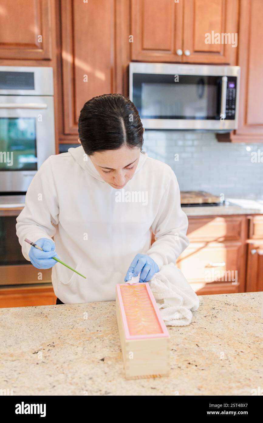Artisan adding final touches to a handmade soap design Stock Photo - Alamy