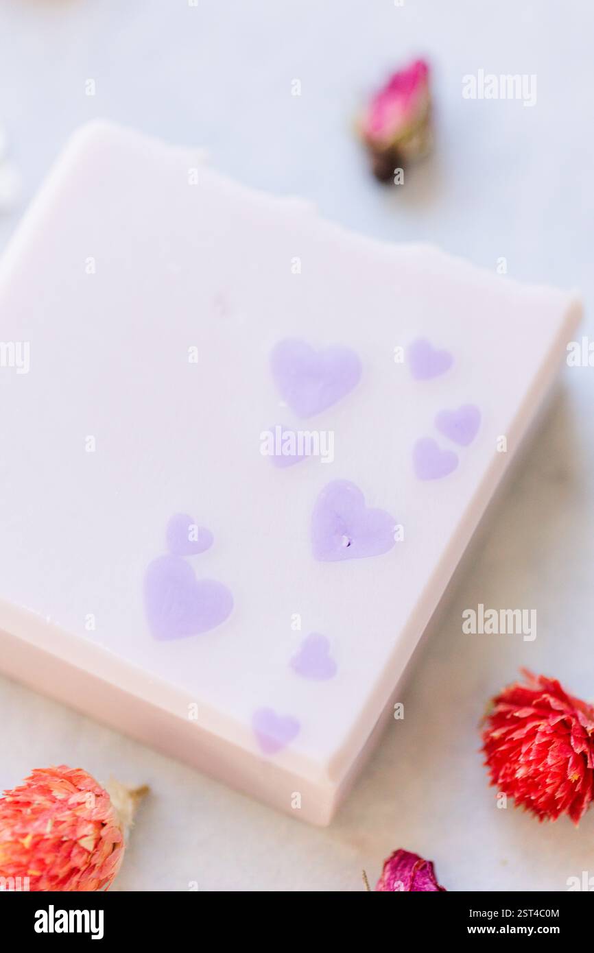 Handmade pastel soap with purple heart details and dried flowers Stock ...