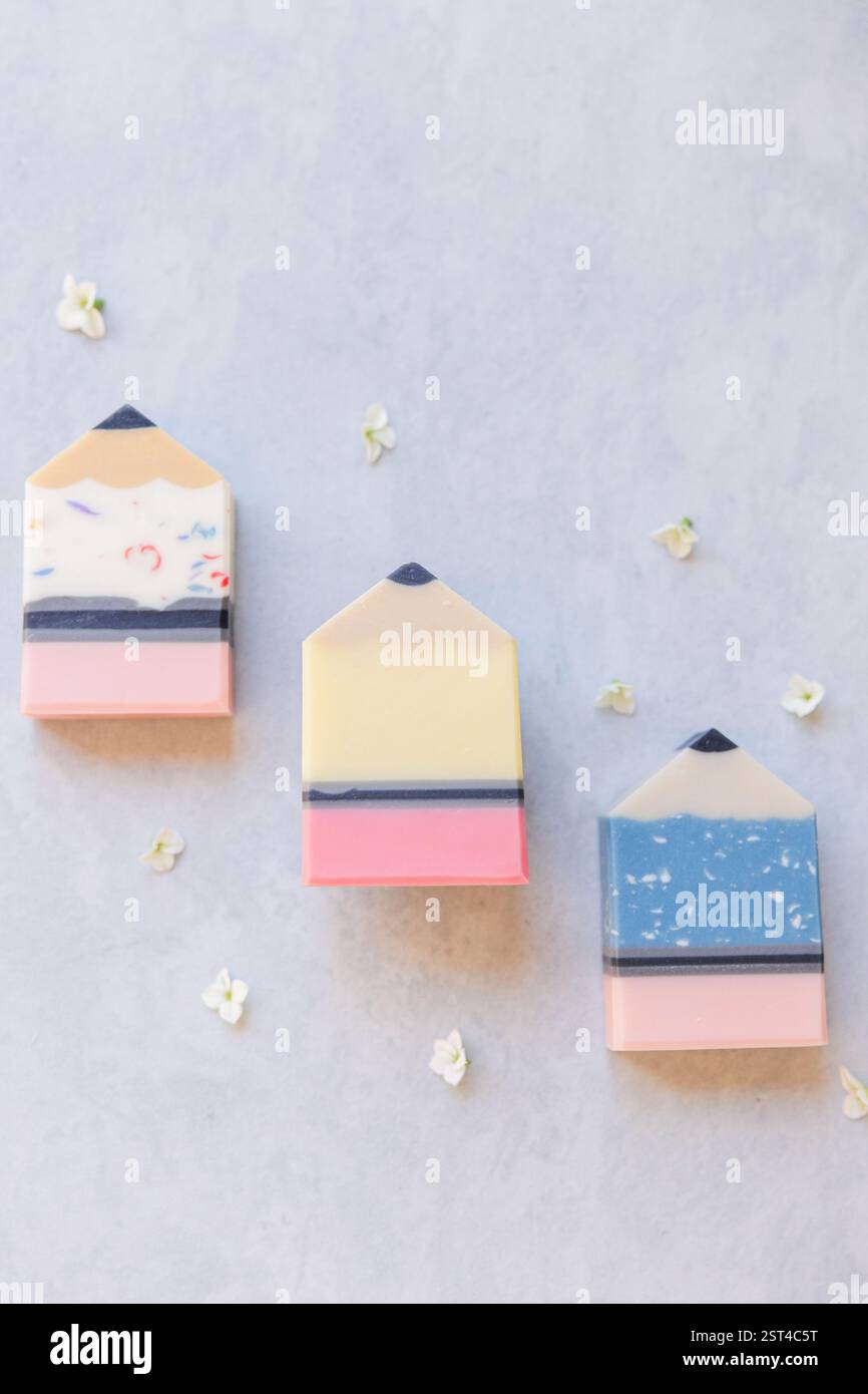 Three handmade pencil-shaped soaps with colorful layered designs Stock ...