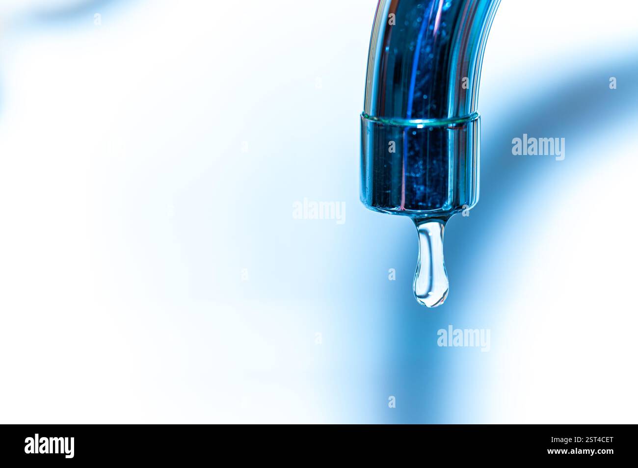 Tap from which drops of water flow. Drought, shortage, rationing and ...