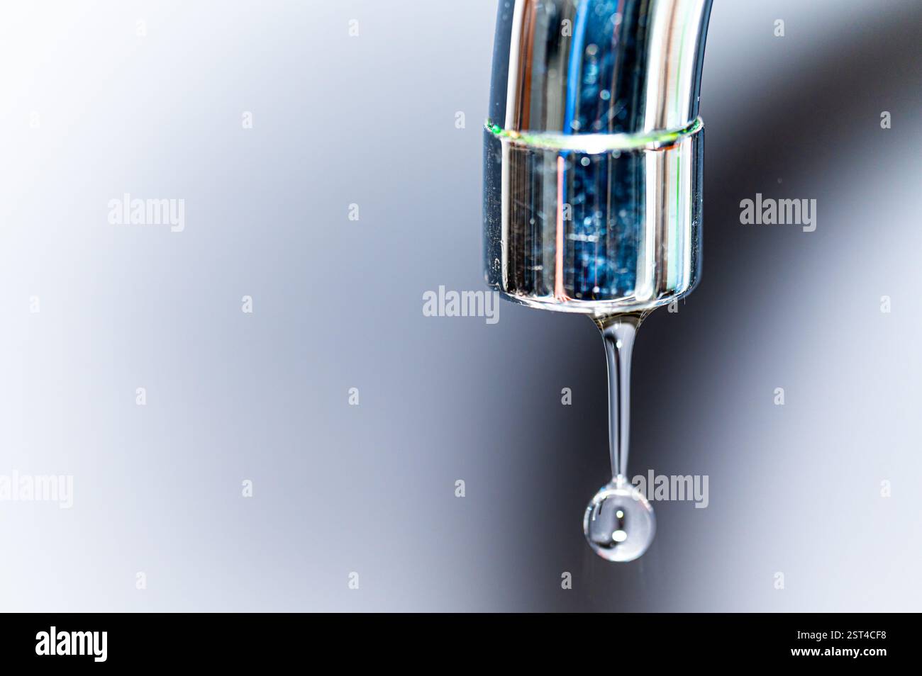 Tap from which drops of water flow. Drought, shortage, rationing and ...