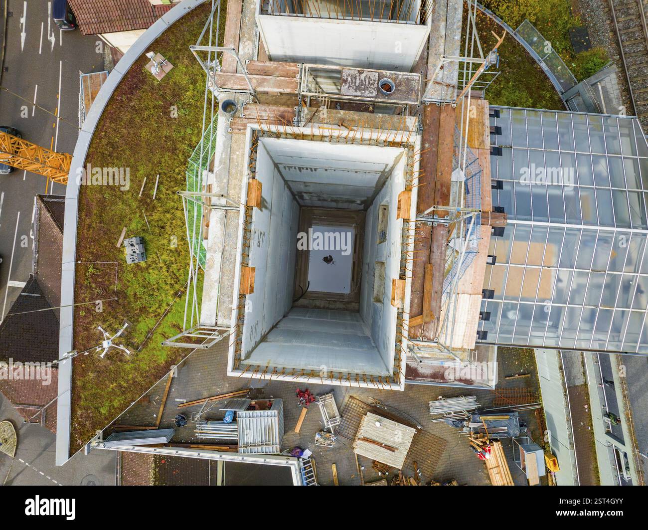 Roof view of a construction site with building materials and structures ...