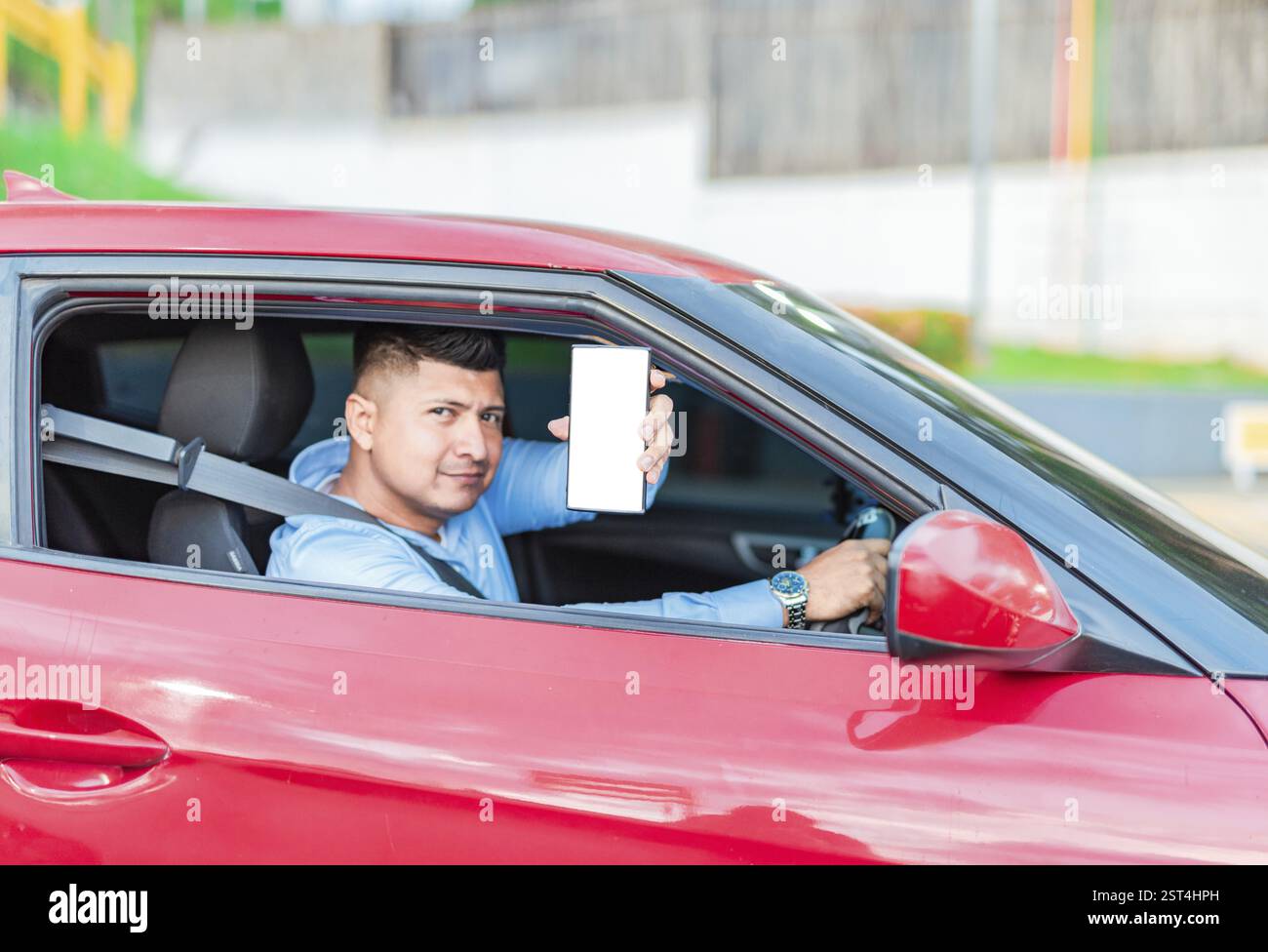 Smiling male driver showing cell phone screen. Handsome driver showing ...
