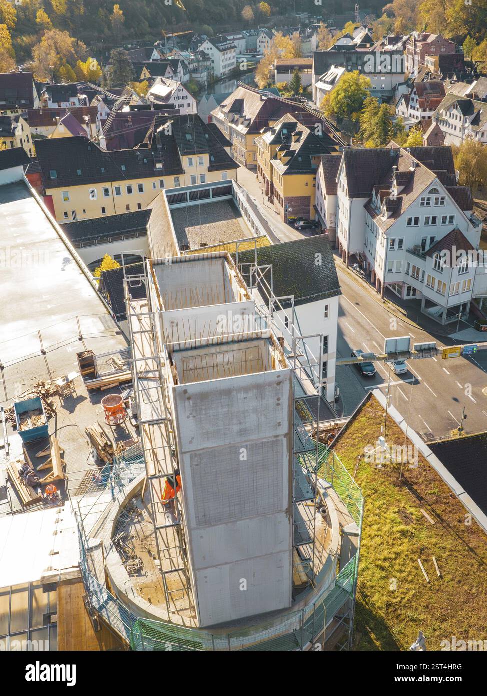View of a town with a building site in the foreground and autumnal ...