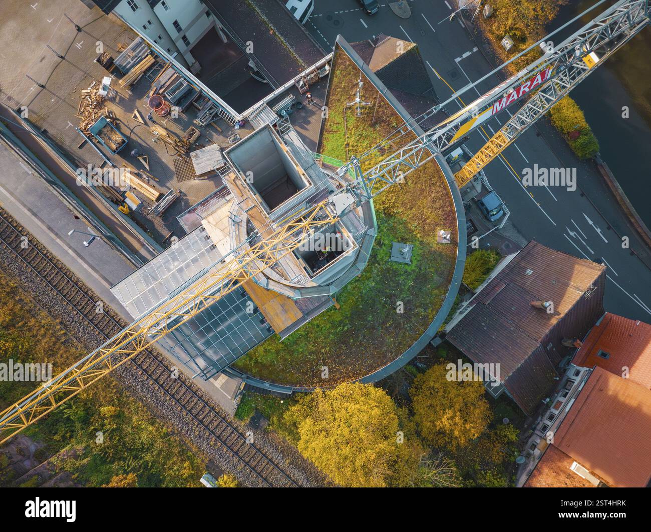 Drone shot of a construction site with crane in an urban environment ...