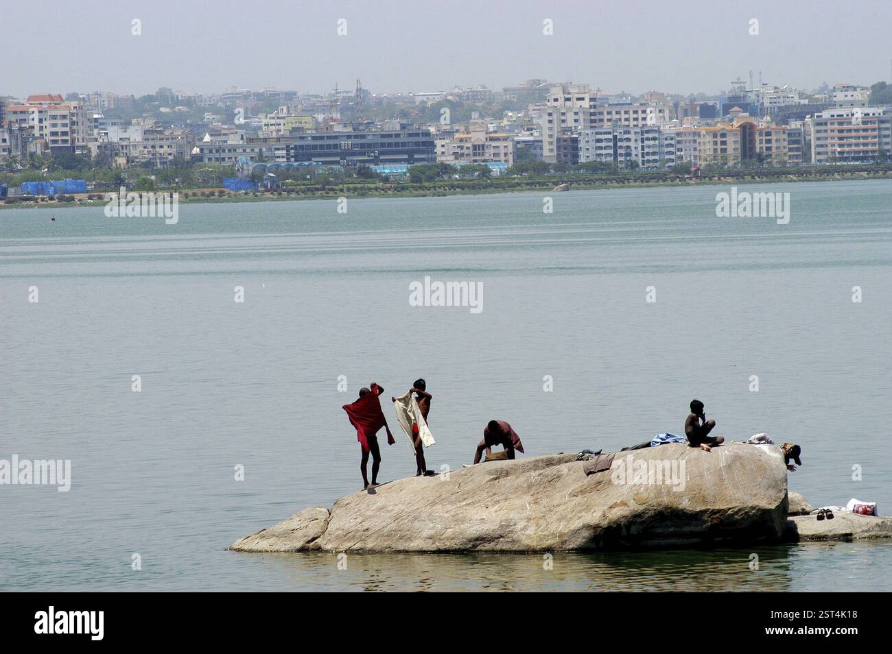 Poor people washing clothes in Hussain Sagar lake in Hyderabad, Andhra ...