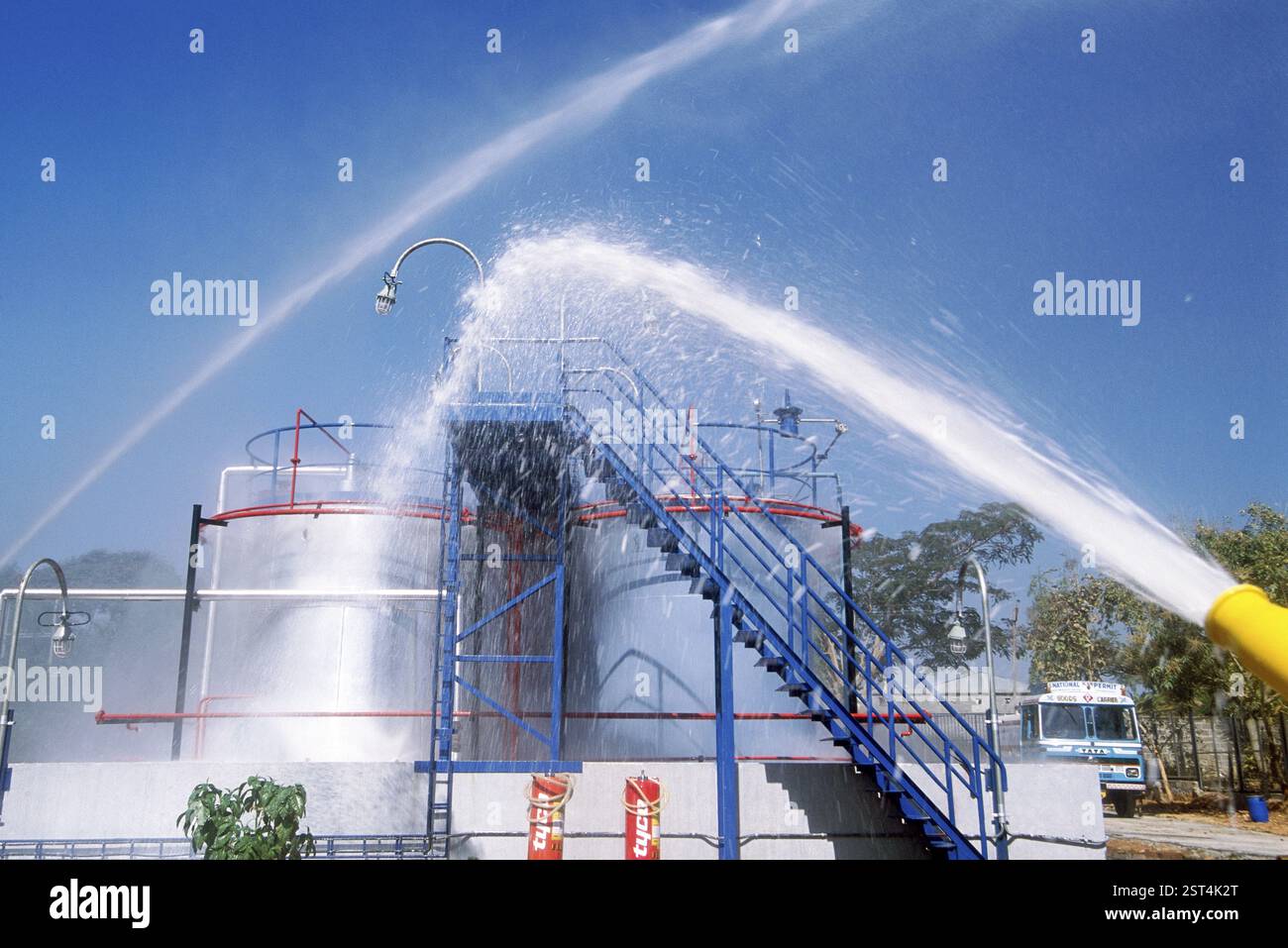 Water jets on storage tanks, india Stock Photo - Alamy