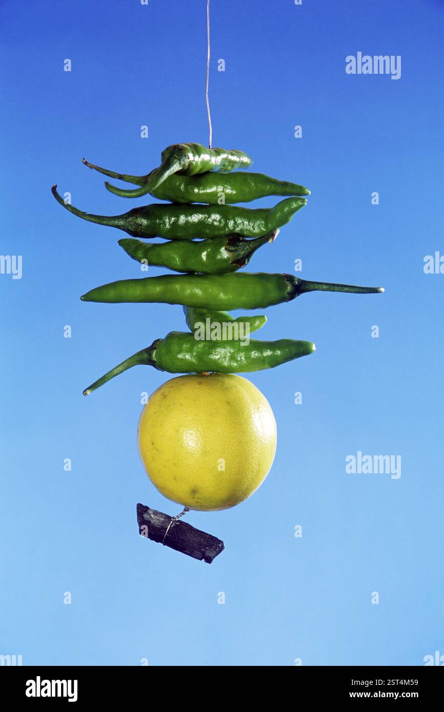 Symbol of good luck, lemon coal and green chillies Stock Photo - Alamy