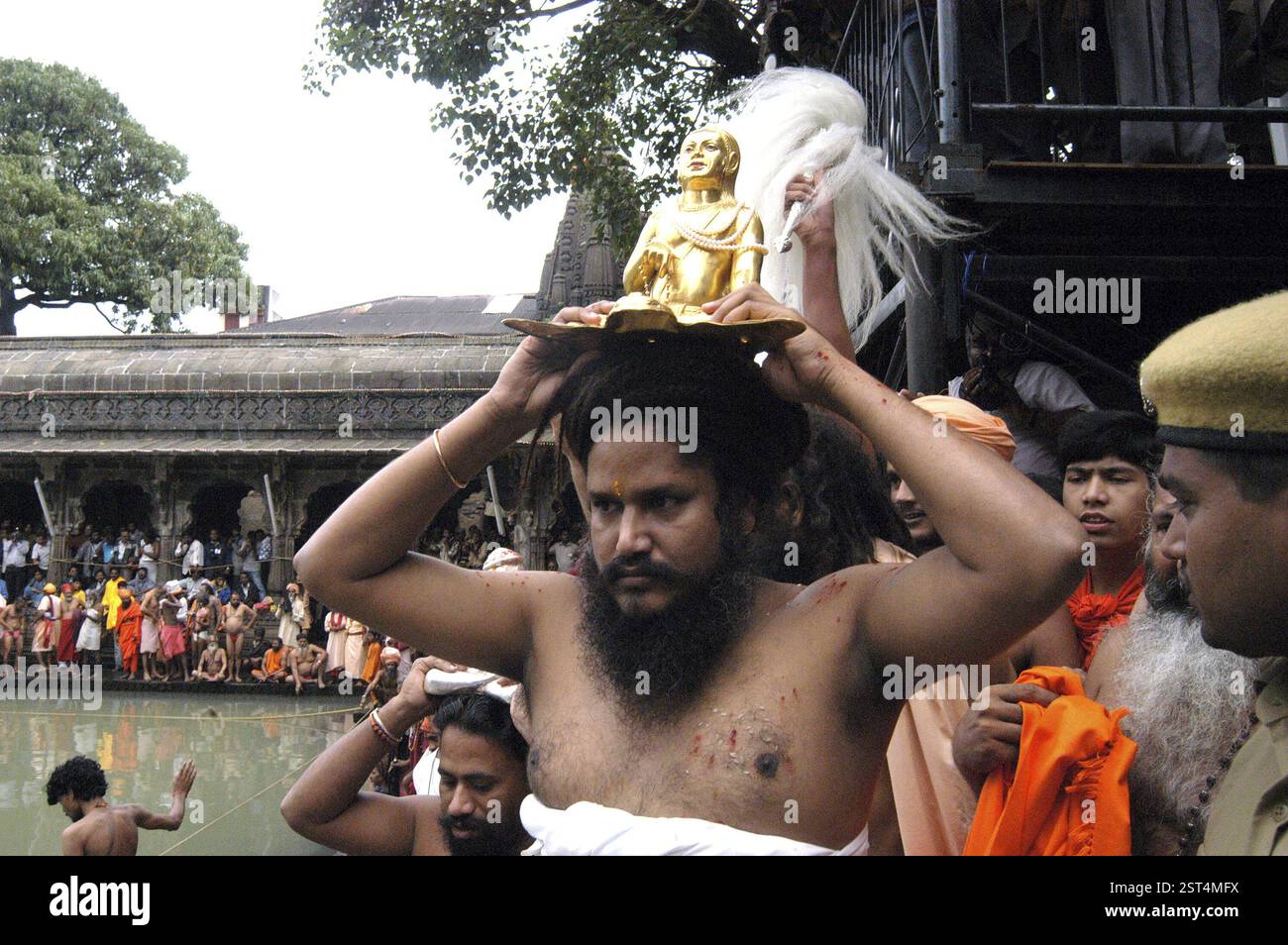 Devotees carry idol of their guru on their head before taking a holy ...