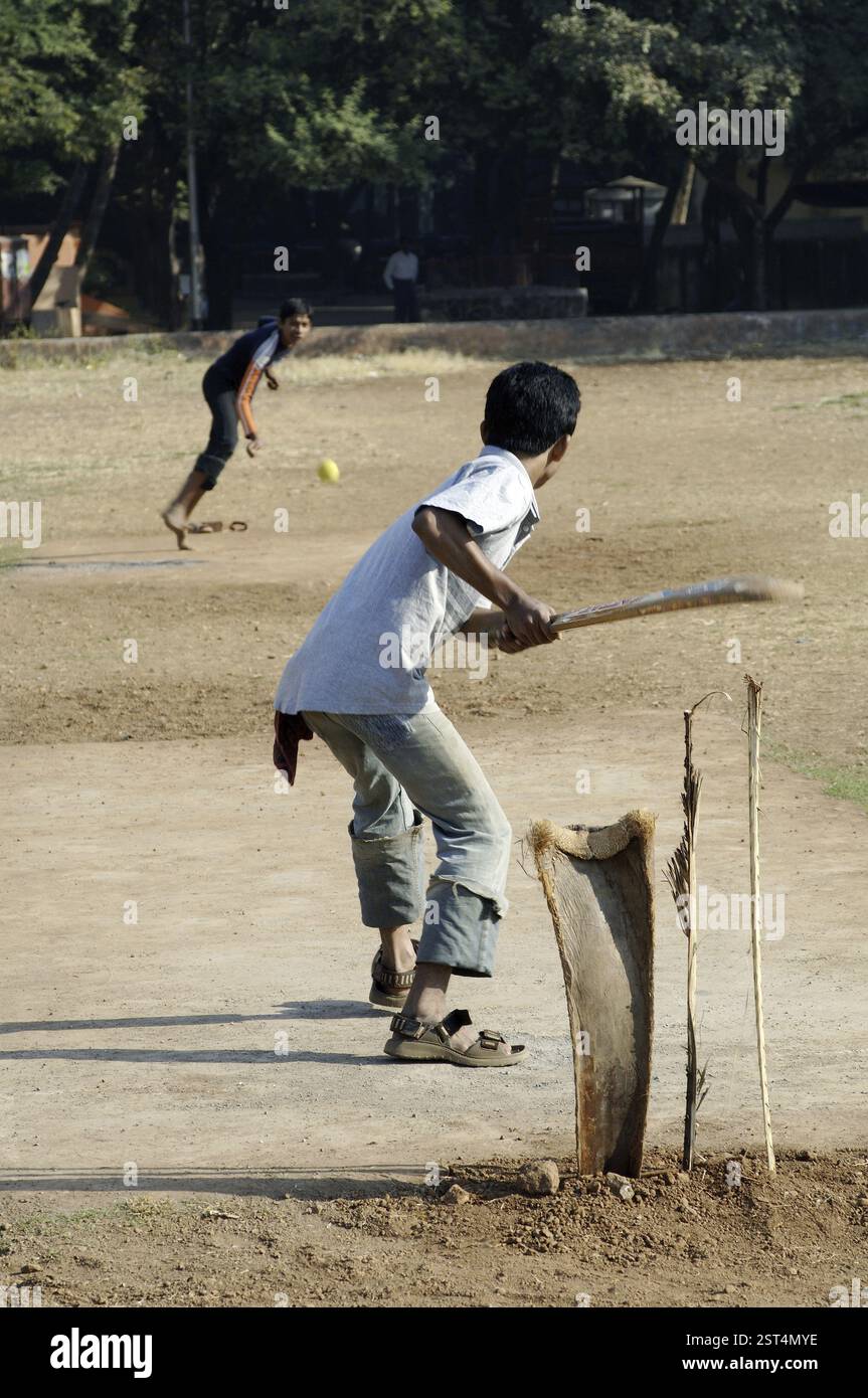 Indian children playing cricket in playground Stock Photo - Alamy