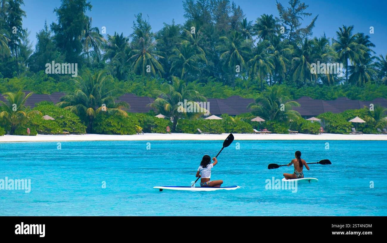 Paddle boarding in the Maldives Stock Photo - Alamy