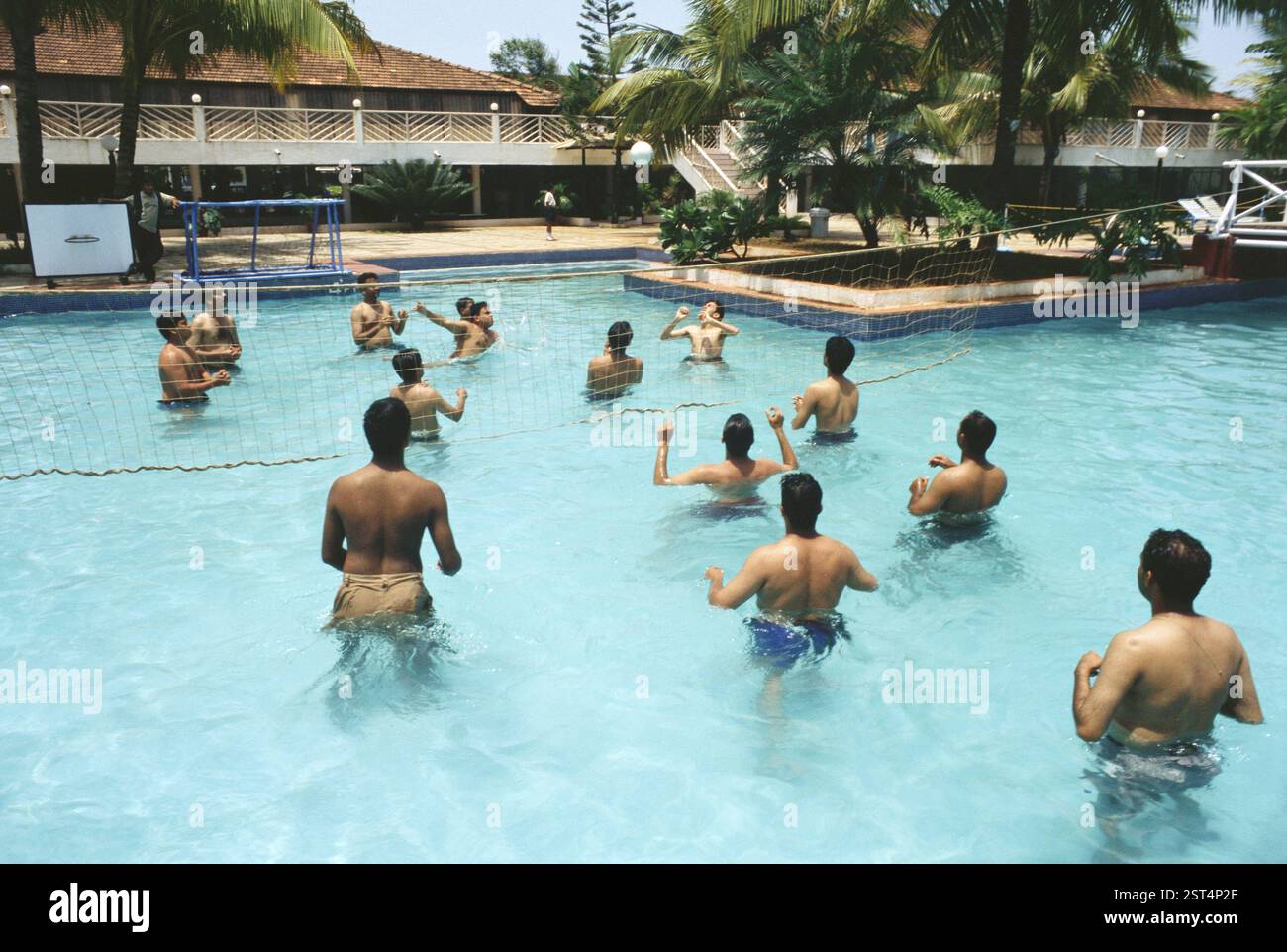 Tourists playing volley ball in swimming pool, Resort Dona Silva, Goa ...