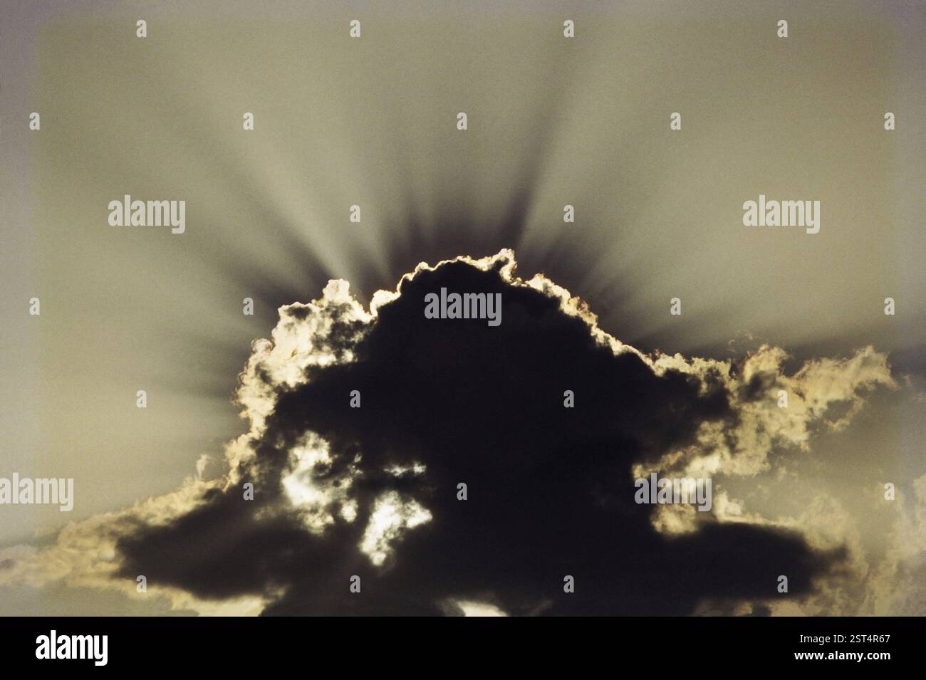 Sky Bright sun rays shining from grey cloud with silver lining tropical ...