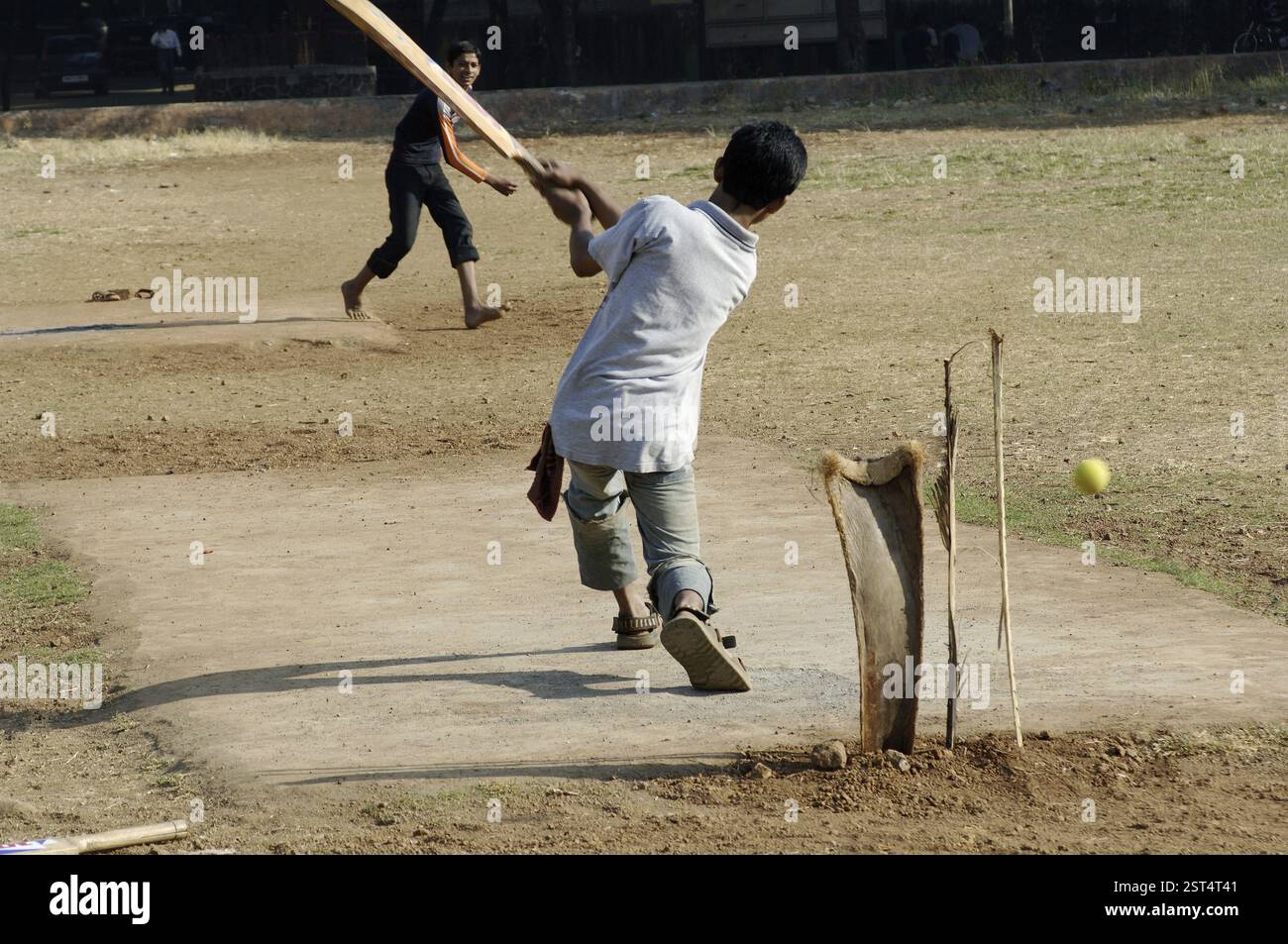 Indian children playing cricket in playground Stock Photo - Alamy