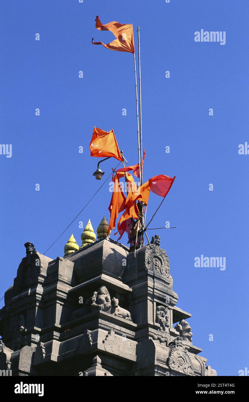 Flags and stone carved pinnacle of Datta temple, Gangapur, Karnataka ...