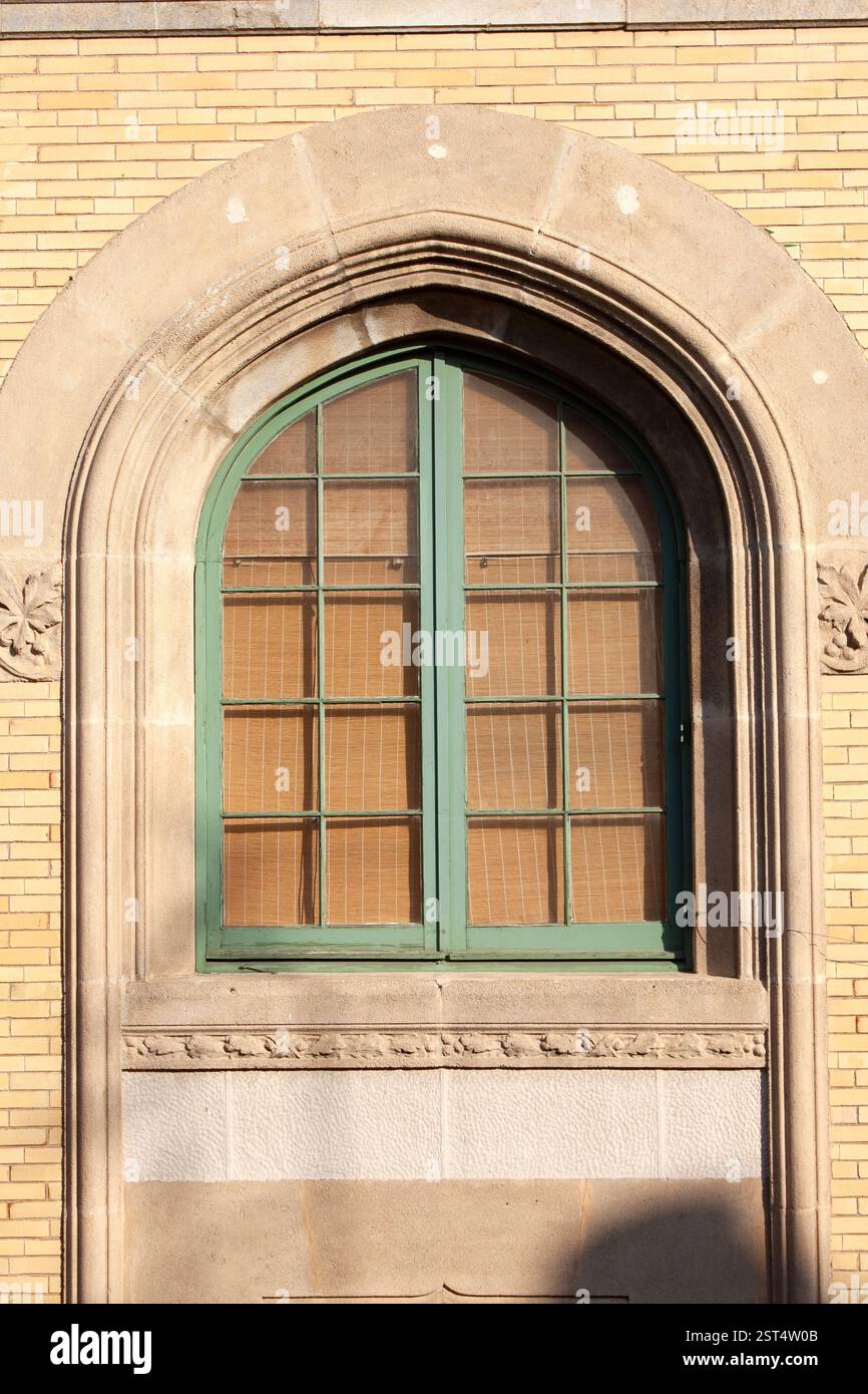 Arched window with divided panes and green trim. Classic architectural ...