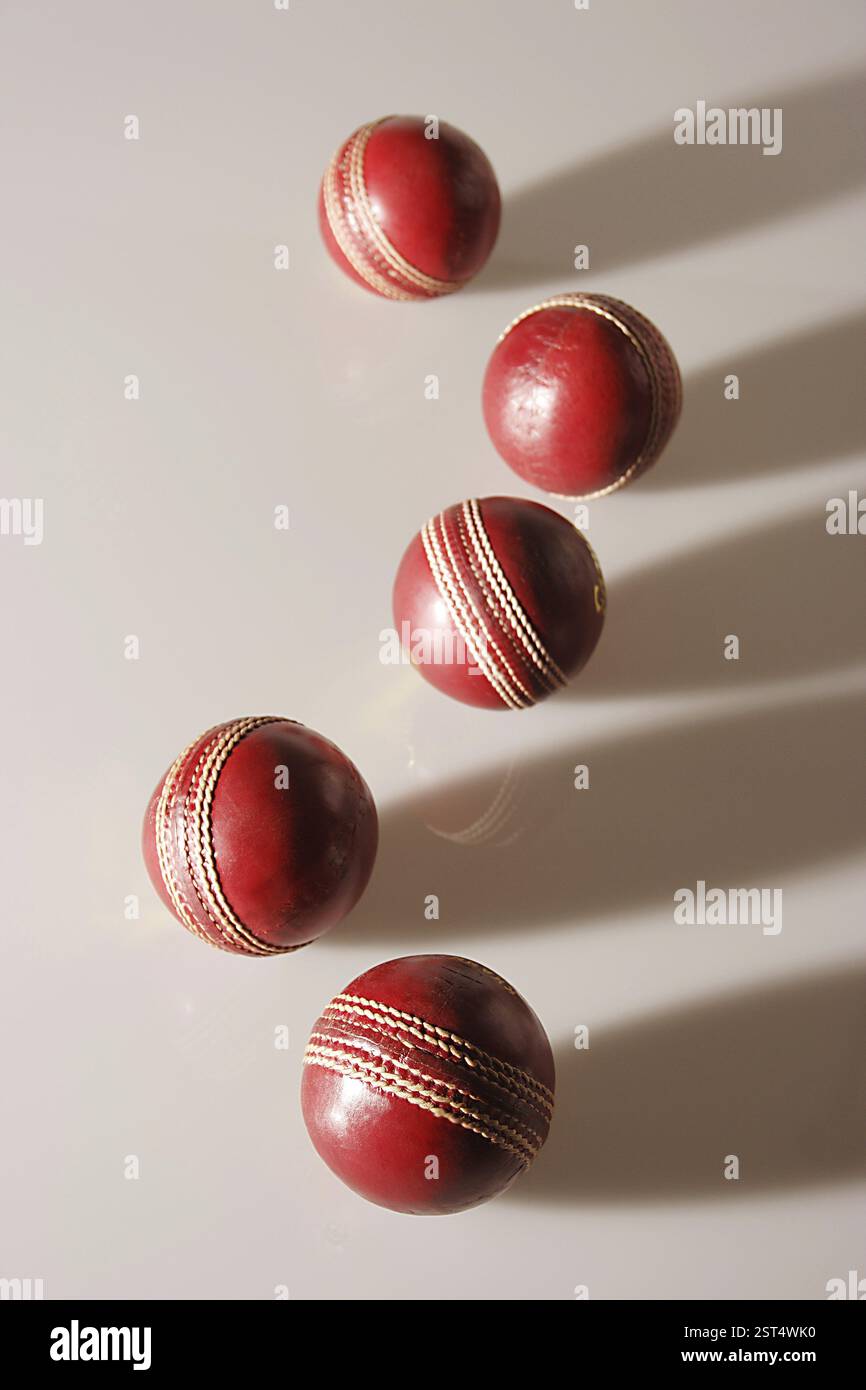 Cricket balls five maroon color Stock Photo - Alamy