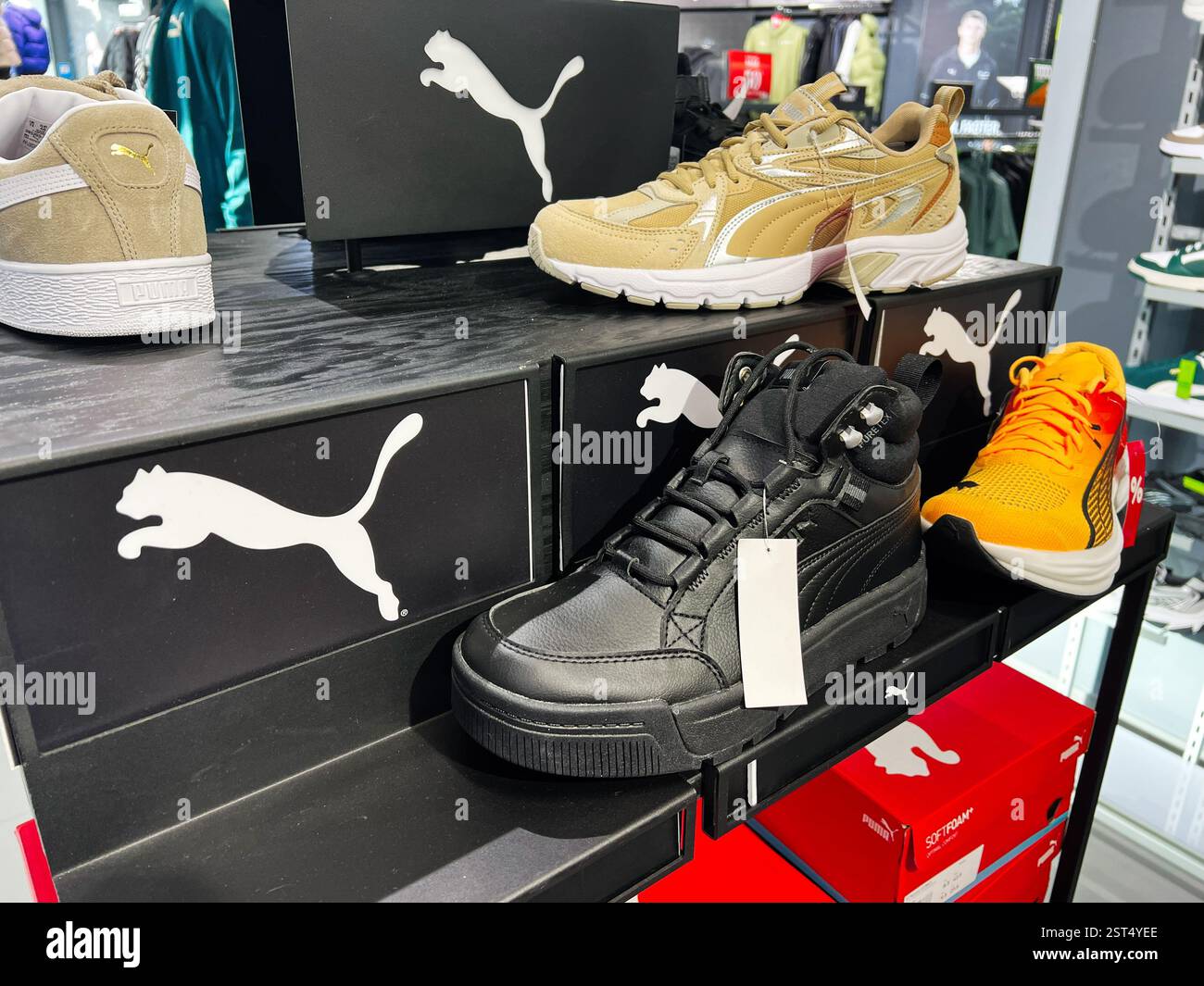 Lviv, Ukraine - February 16, 2025: A variety of Puma footwear on boxed shelves in a modern ...