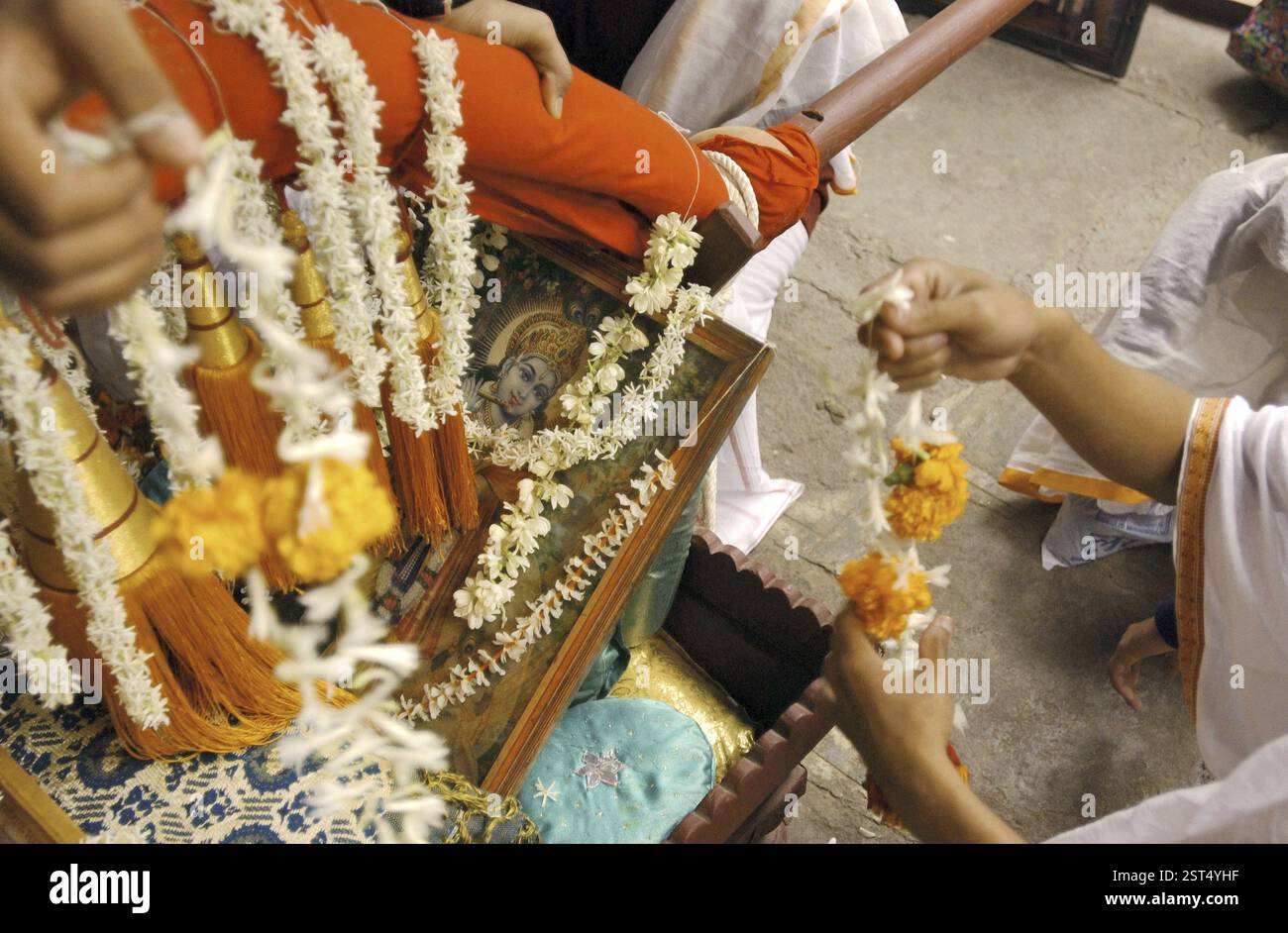 Devotees decorate Krishna 'palkhi' before the procession, Poona ...