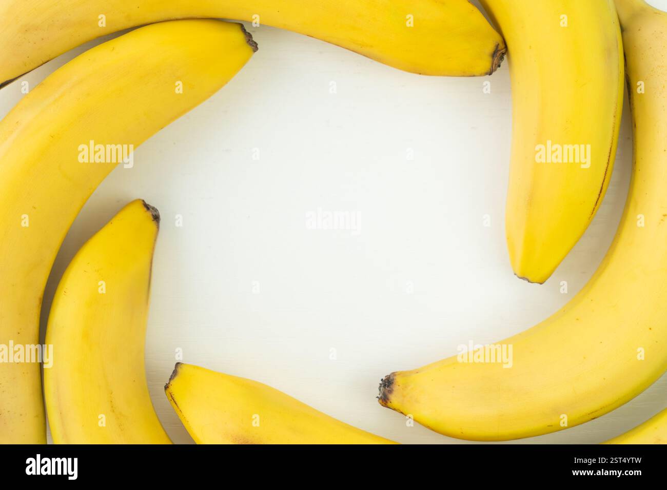 Bananas folded in the shape of a circle lie on white background of the ...
