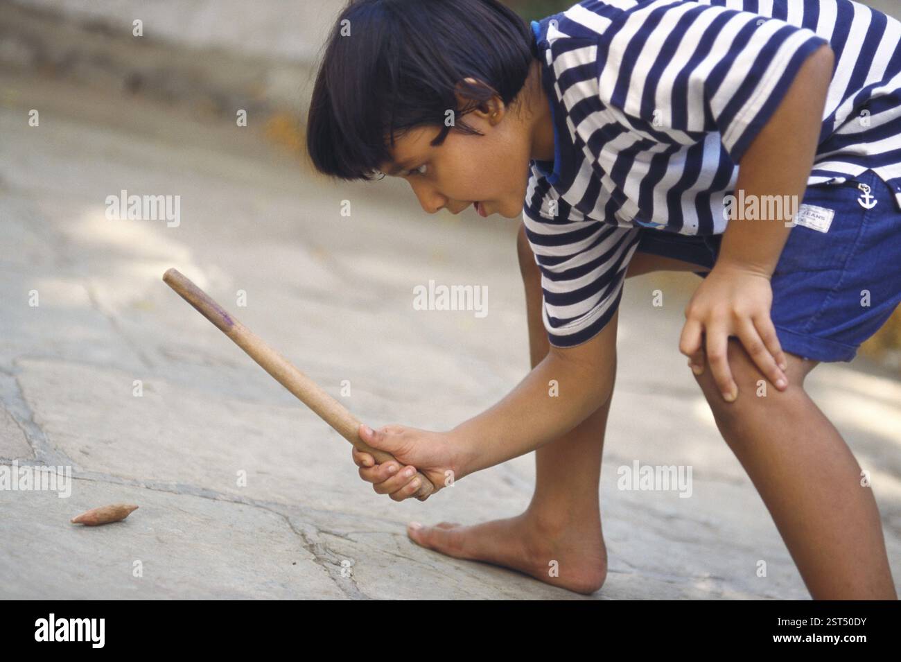 South Asian Indian girl playing Gilli danda game MR#201 Stock Photo - Alamy