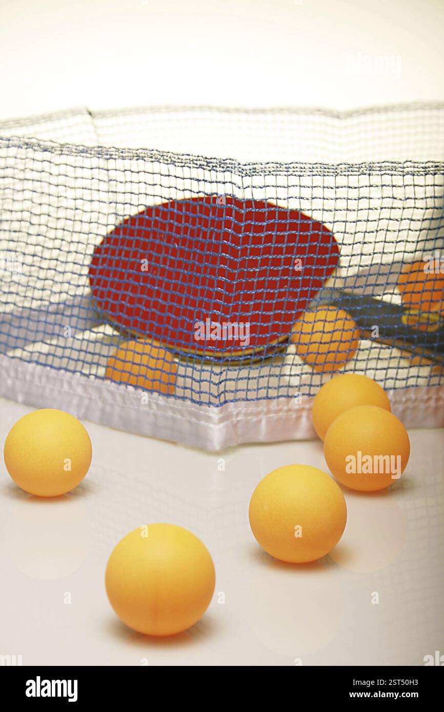 Table tennis balls with racket net Stock Photo - Alamy