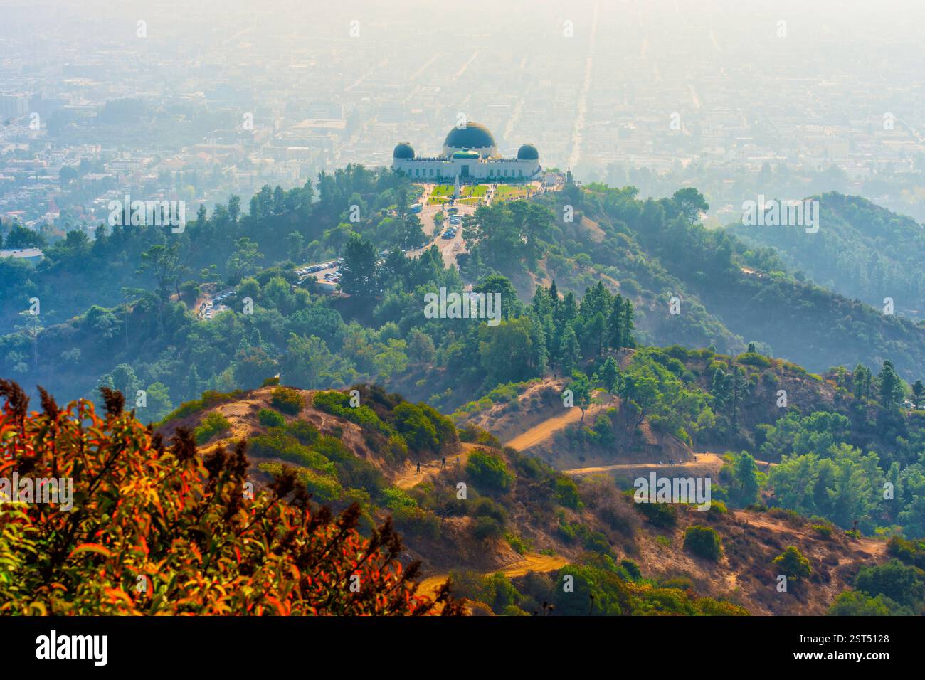 Aerial view of Griffith Observatory surrounded by lush hills over hazy ...