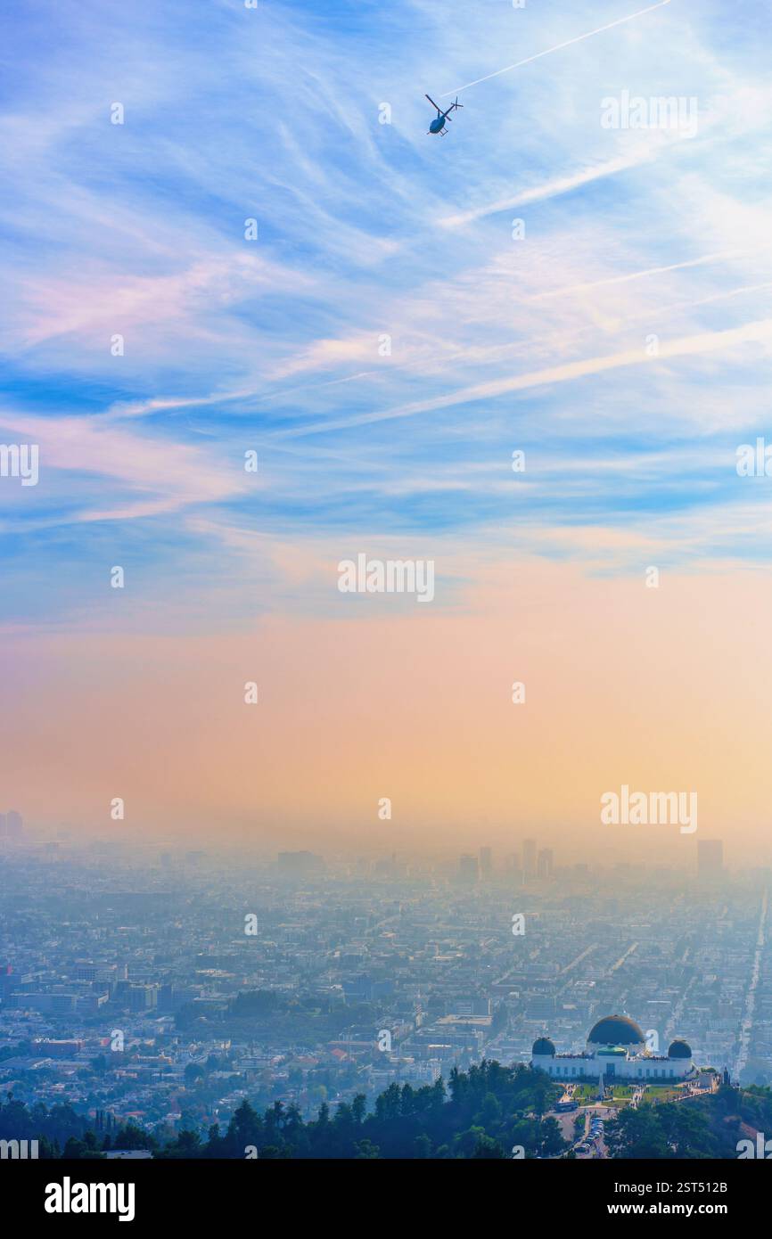 Stunning aerial view of Los Angeles, with a helicopter flying above the ...