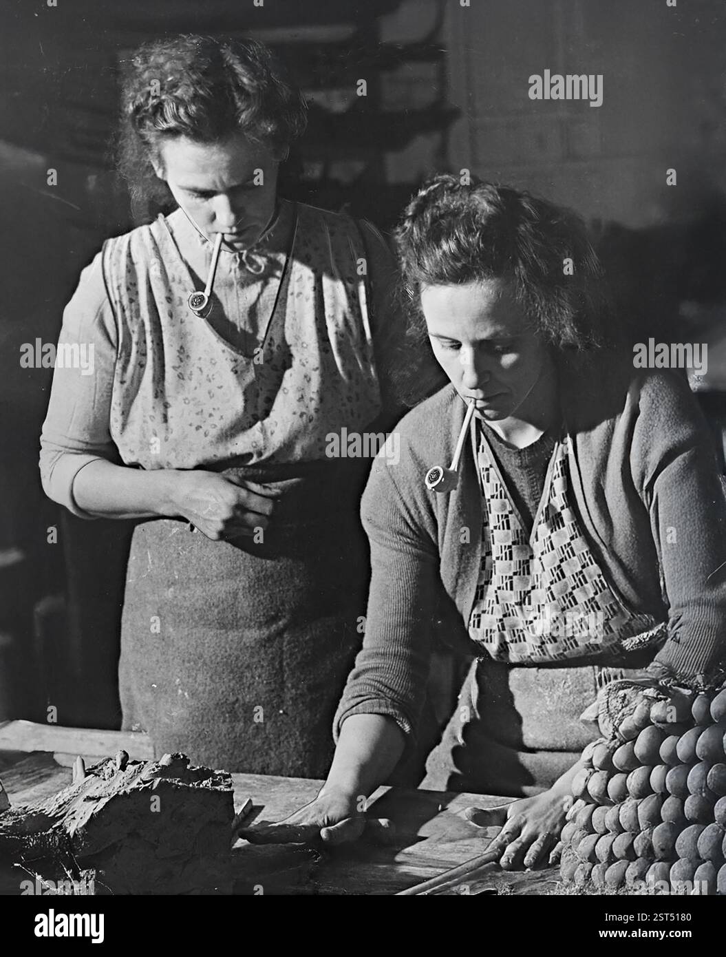 Pipe smoking women workers making clay pipes at Broseley in Shropshire ...