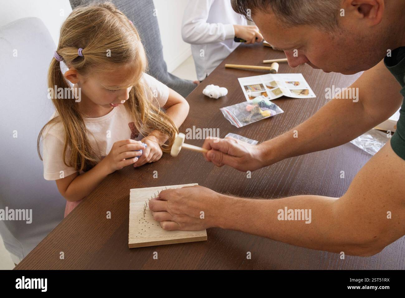 Father and daughter bonding over a DIY craft project, sharing quality ...