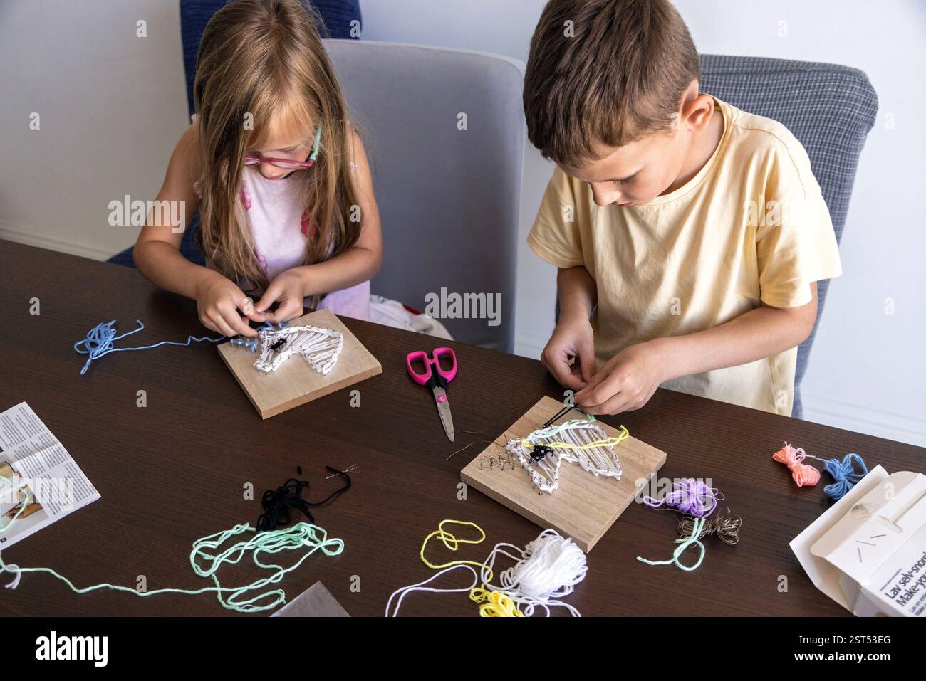 Two kids create string art together, improving fine motor skills ...