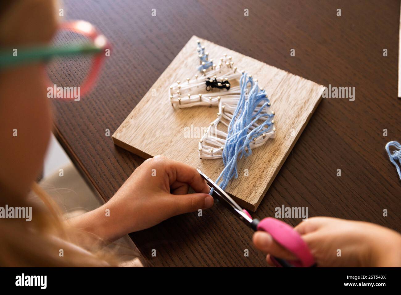 girl threading string for art. Strengthening fine motor skills, focus ...