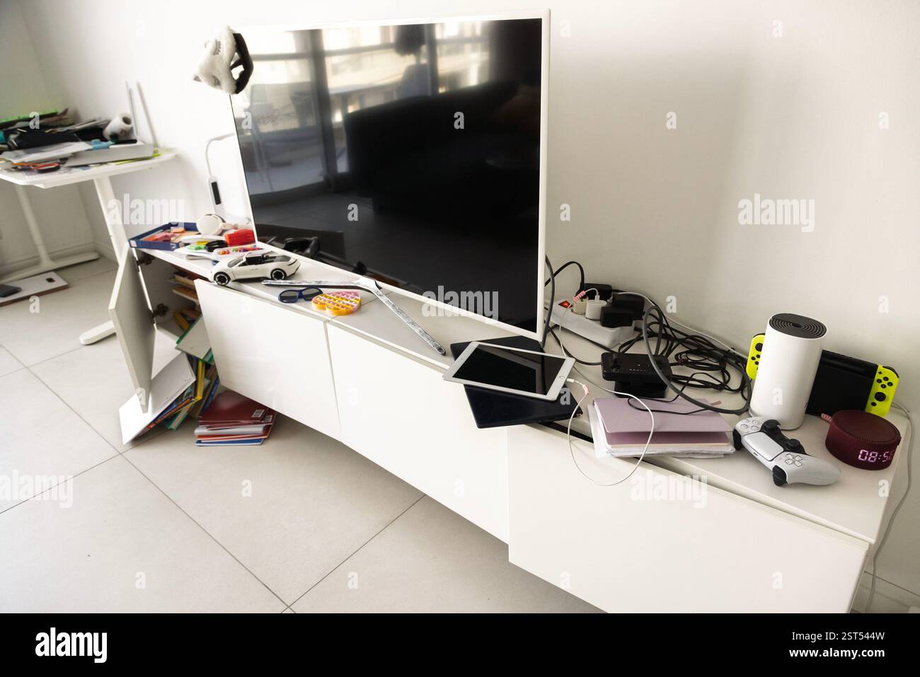 Messy living room with scattered items and gadgets, showcasing the need ...