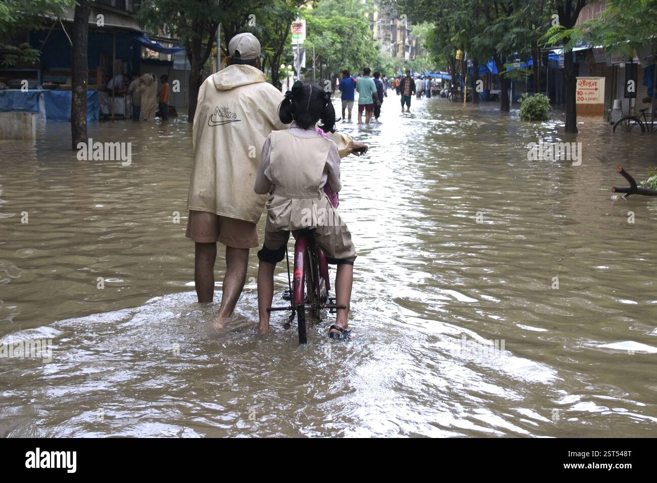 Indian children bicycle rain hi-res stock photography and images - Alamy