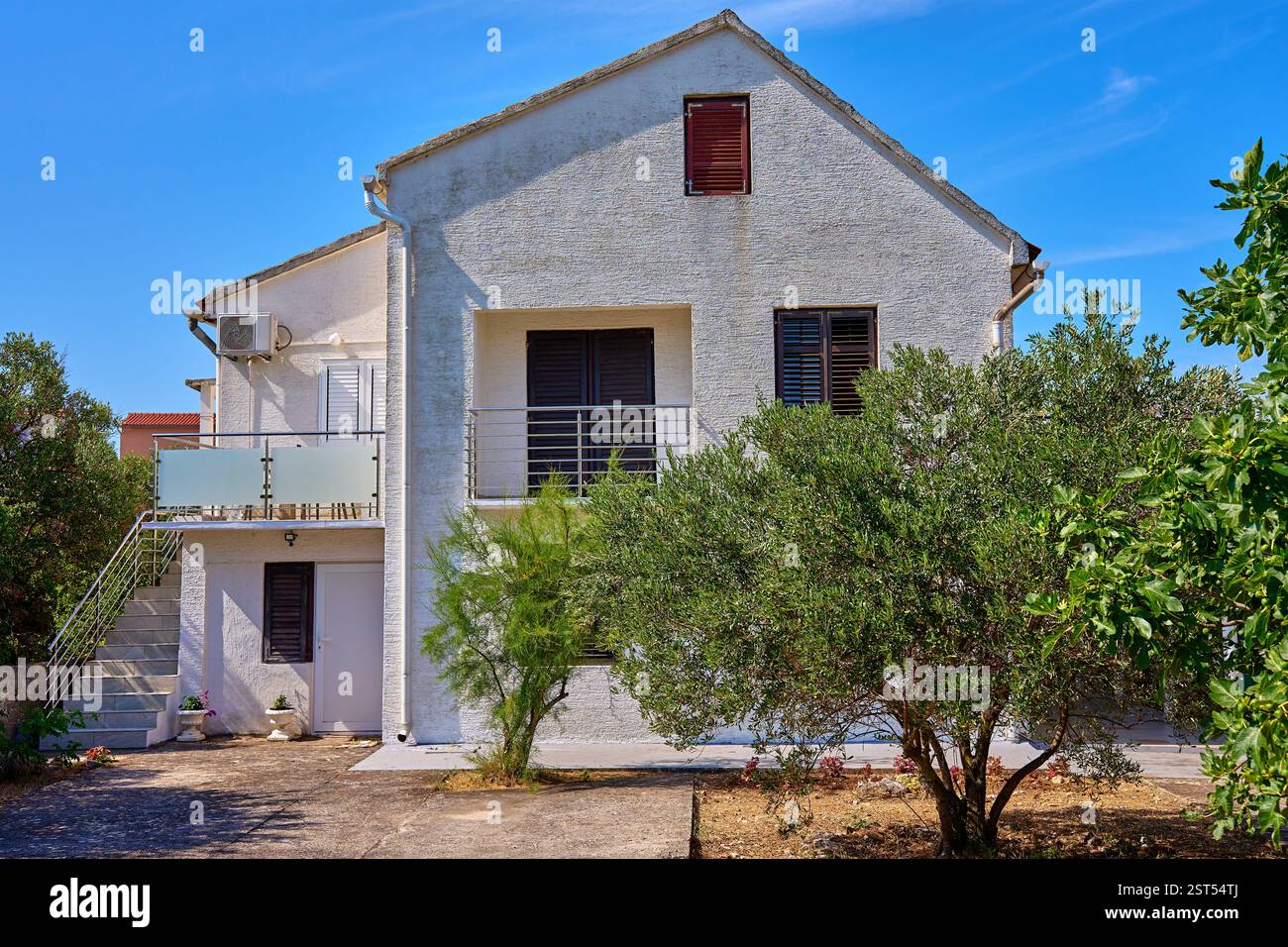White Mediterranean-style house with balcony, surrounded by olive trees ...