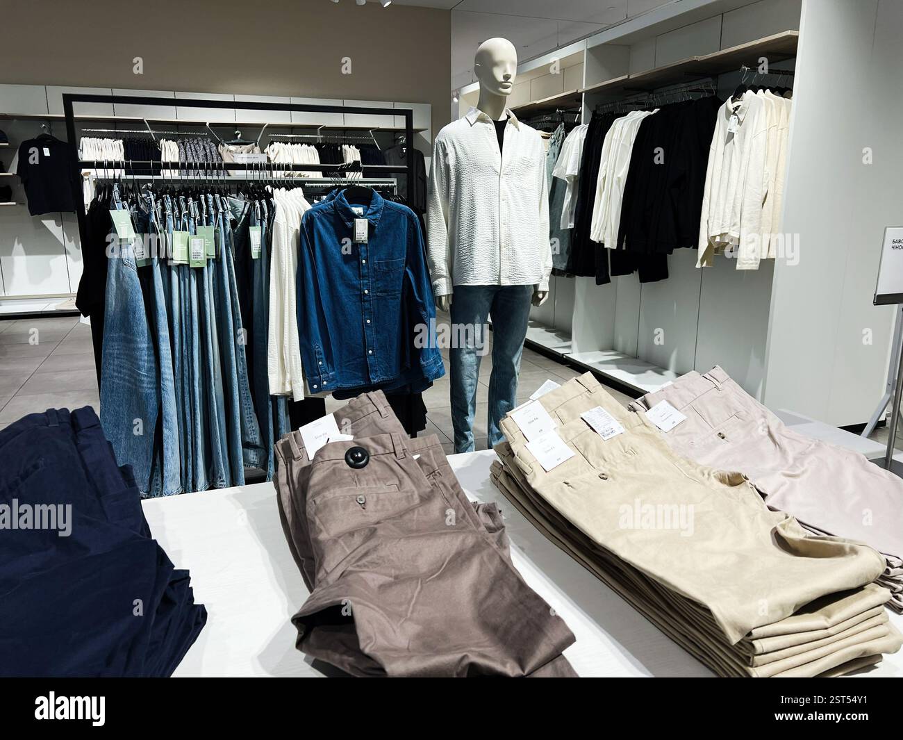 Lviv, Ukraine - February 16, 2025: Clothing store interior showing neat ...